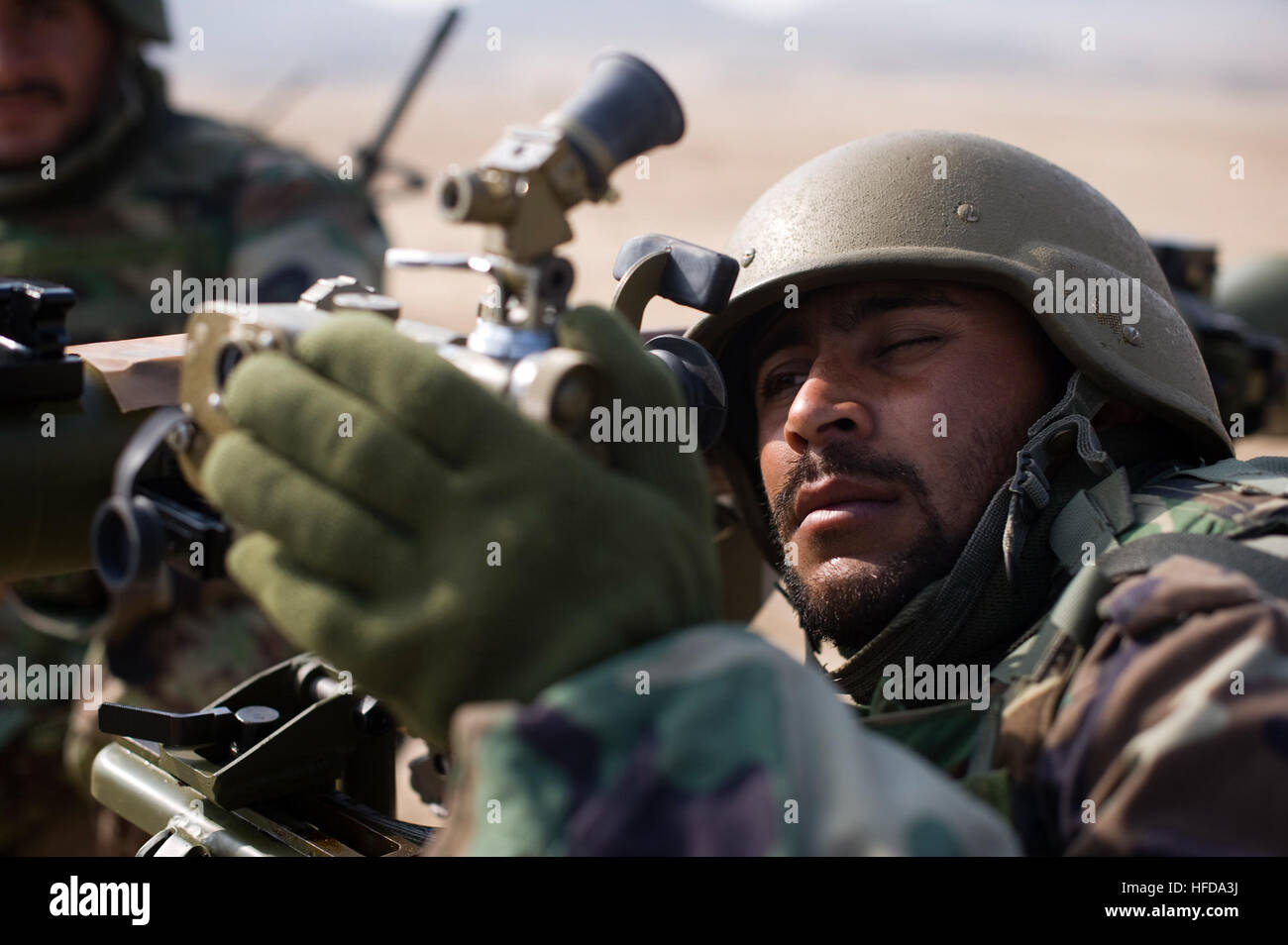 An Afghan National Army soldier sights in a SPG9 anti-tank weapon ...