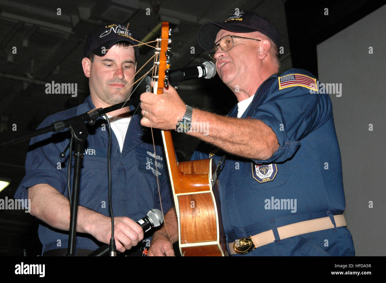 Larry Seever, a retired Navy chief, performs a song with some help from ...