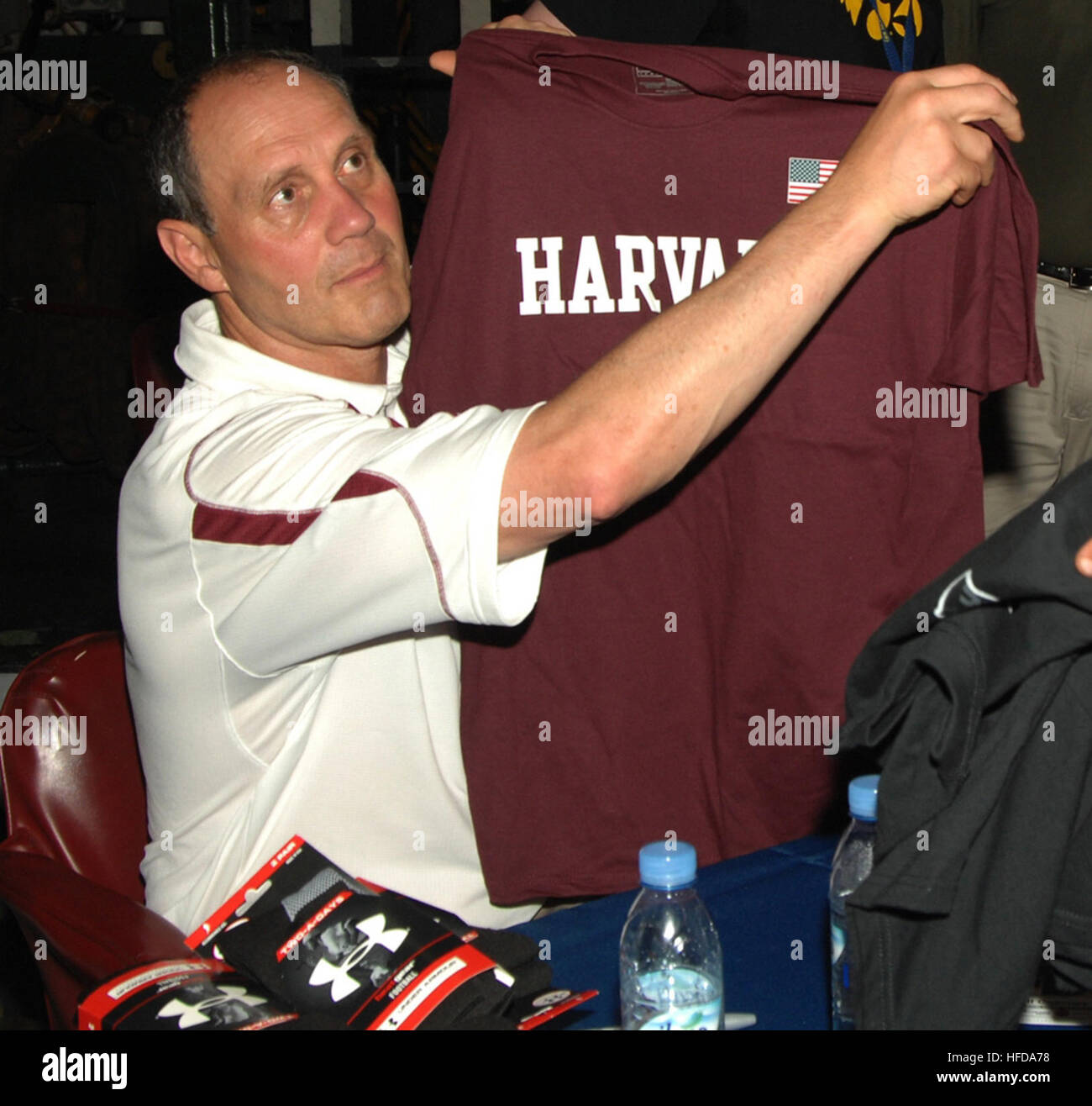 Harvard head football coach Tim Murphy holds up a sweatshirt while ...