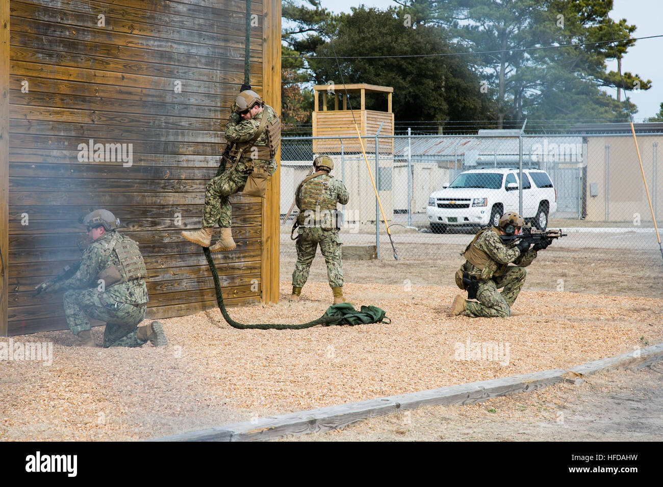 Explosive Ordnance Disposal Technicians fast rope from a tower during a ...