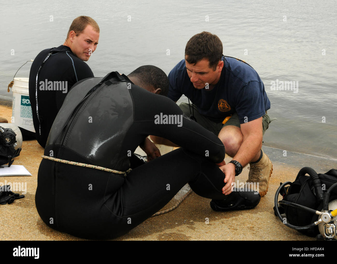 Navy Divers from Mobile Diving and Salvage Unit 2 assess the medical ...