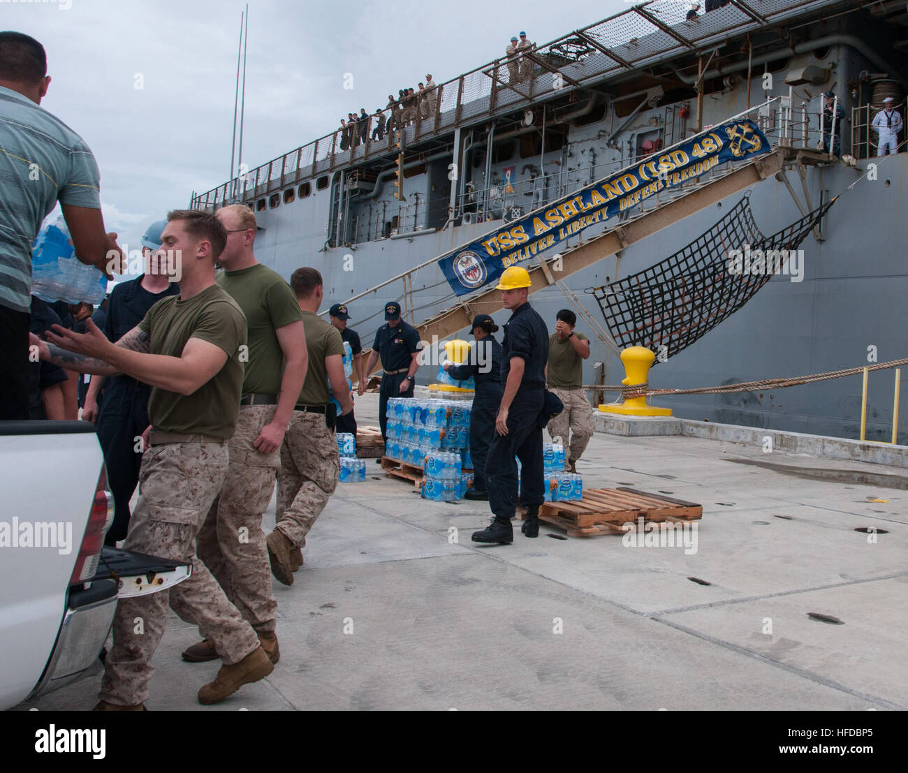 APRA HARBOR, Guam (Aug. 6, 2015) Sailors and Marines load cases of ...