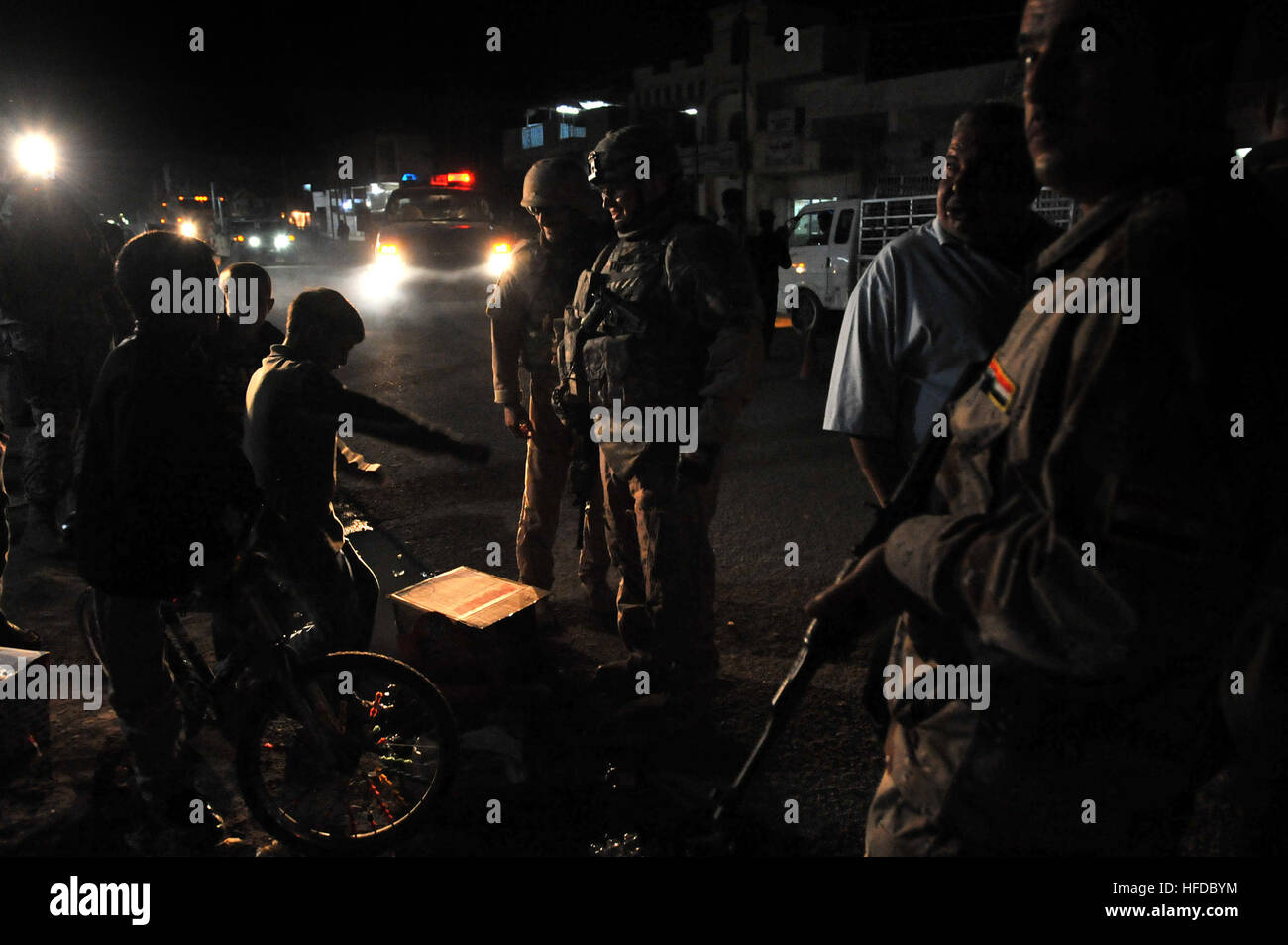 U.S. Air Force Capt. Matthew Ballanco speaks with Iraqi children during ...