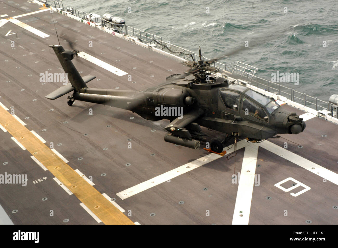 U.S. Army AH-64 Apache helicopter prepares to launch from USS Nassau ...