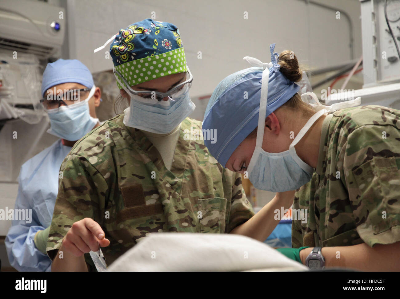 U.S. Army First Lt. Suzzane Laux, center, an operating room nurse ...