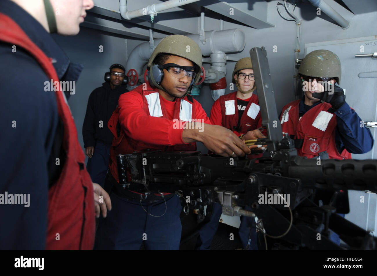 U.S. Navy Aviation Ordnanceman Airman Trevon Williams, center, loads a ...