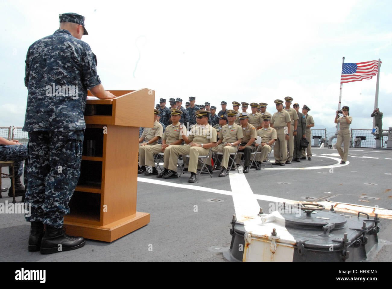 U.S. Navy Capt. Paul Schlise, at lectern, the commodore of Destroyer ...