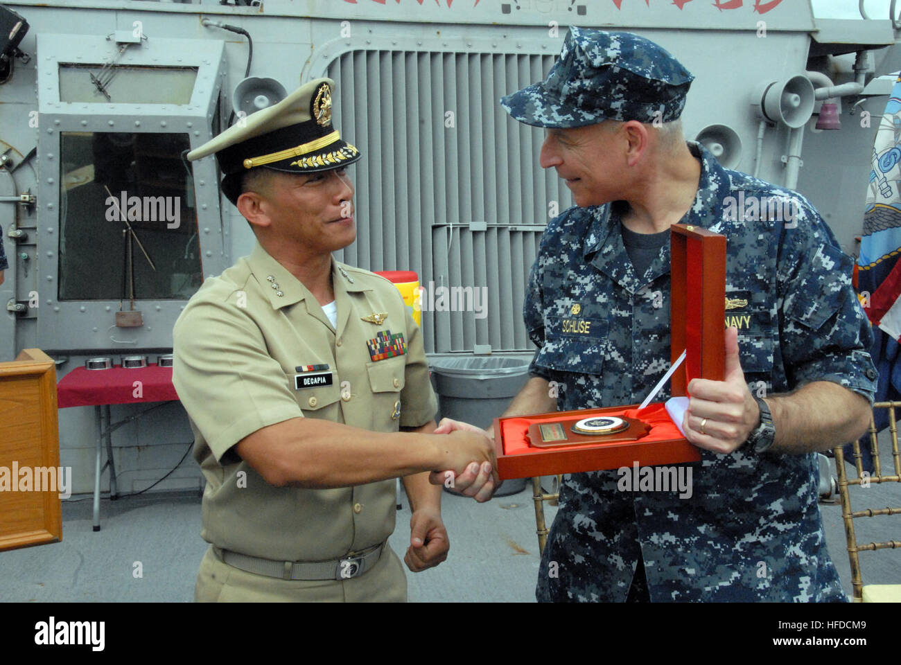 U.S. Navy Capt. Paul Schlise, right, the commodore of Destroyer ...