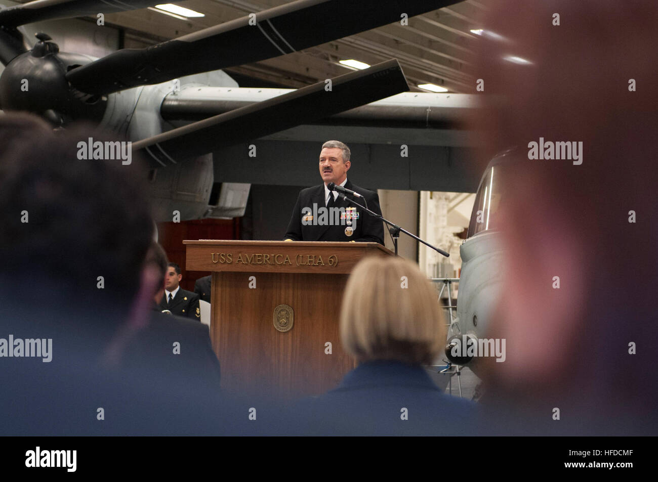 U.S. Navy Capt. Robert A. Hall Jr., at lectern, the commanding officer ...