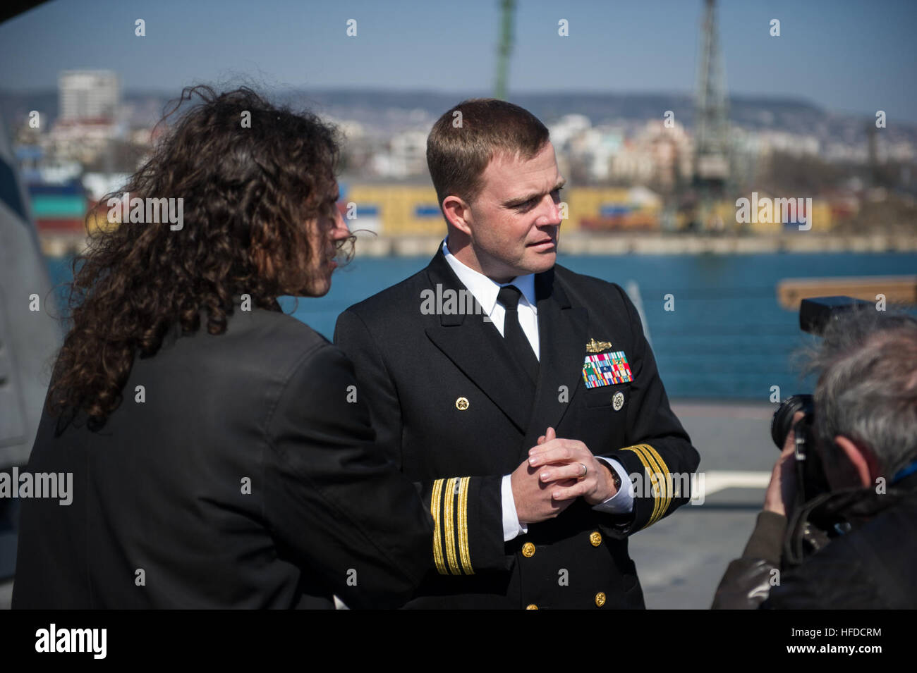 U.S. Navy Cmdr. Andrew Biehn, center, the commanding officer of the ...
