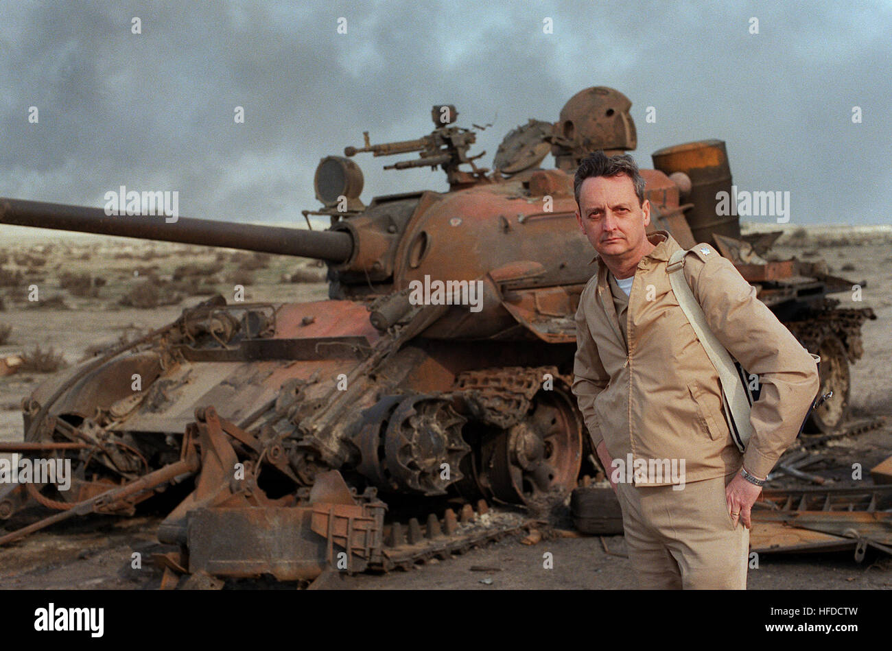 A U.S. Navy commander stands near an Iraqi T-55 main battle tank that ...