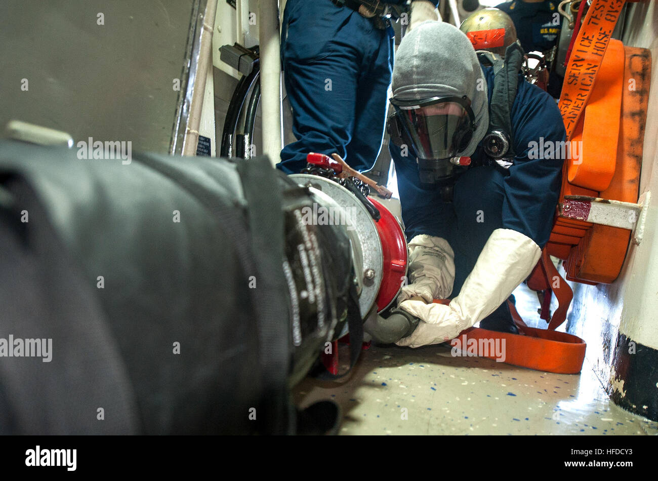 U.S. Navy Damage Controlman Fireman Keaten Dunn attaches a fire main ...