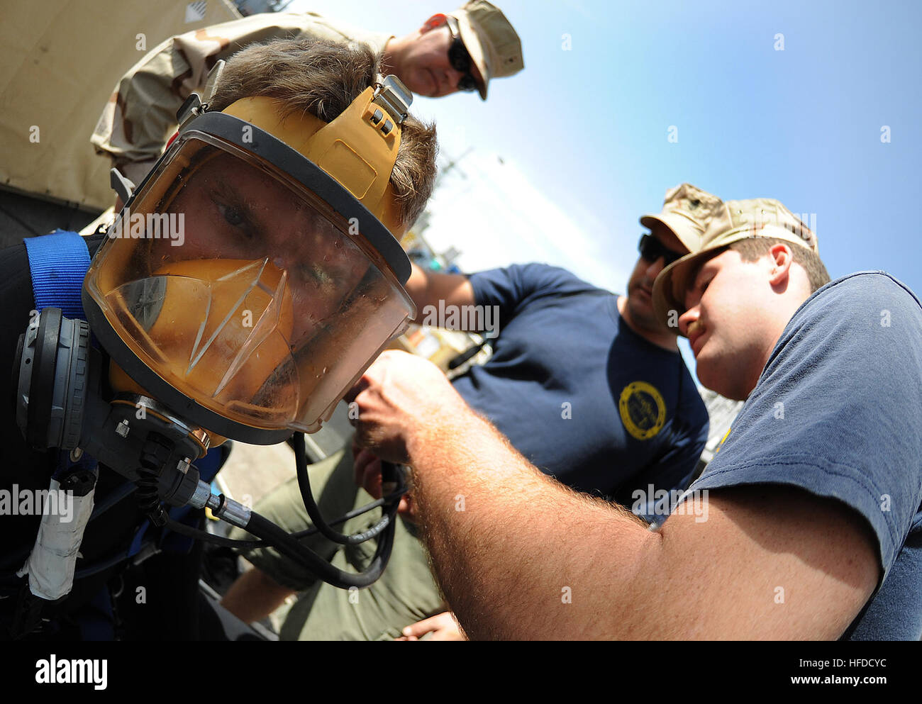 U.S. Navy Diver 2nd Class Brady Gallert, right, helps Navy Diver 2nd ...