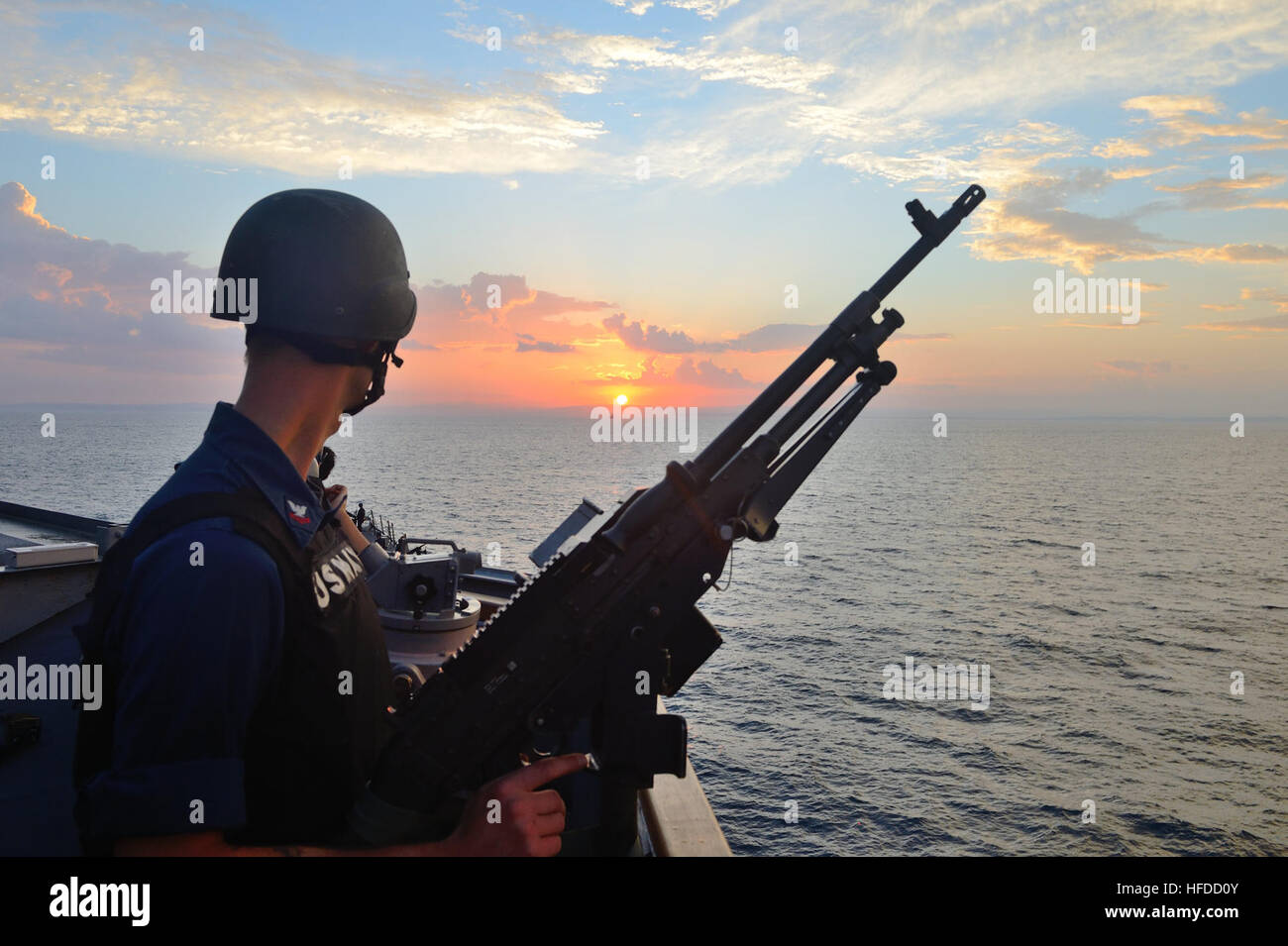 U.S. Navy Gunner's Mate 2nd Class Kent Ferguson stands watch aboard the ...