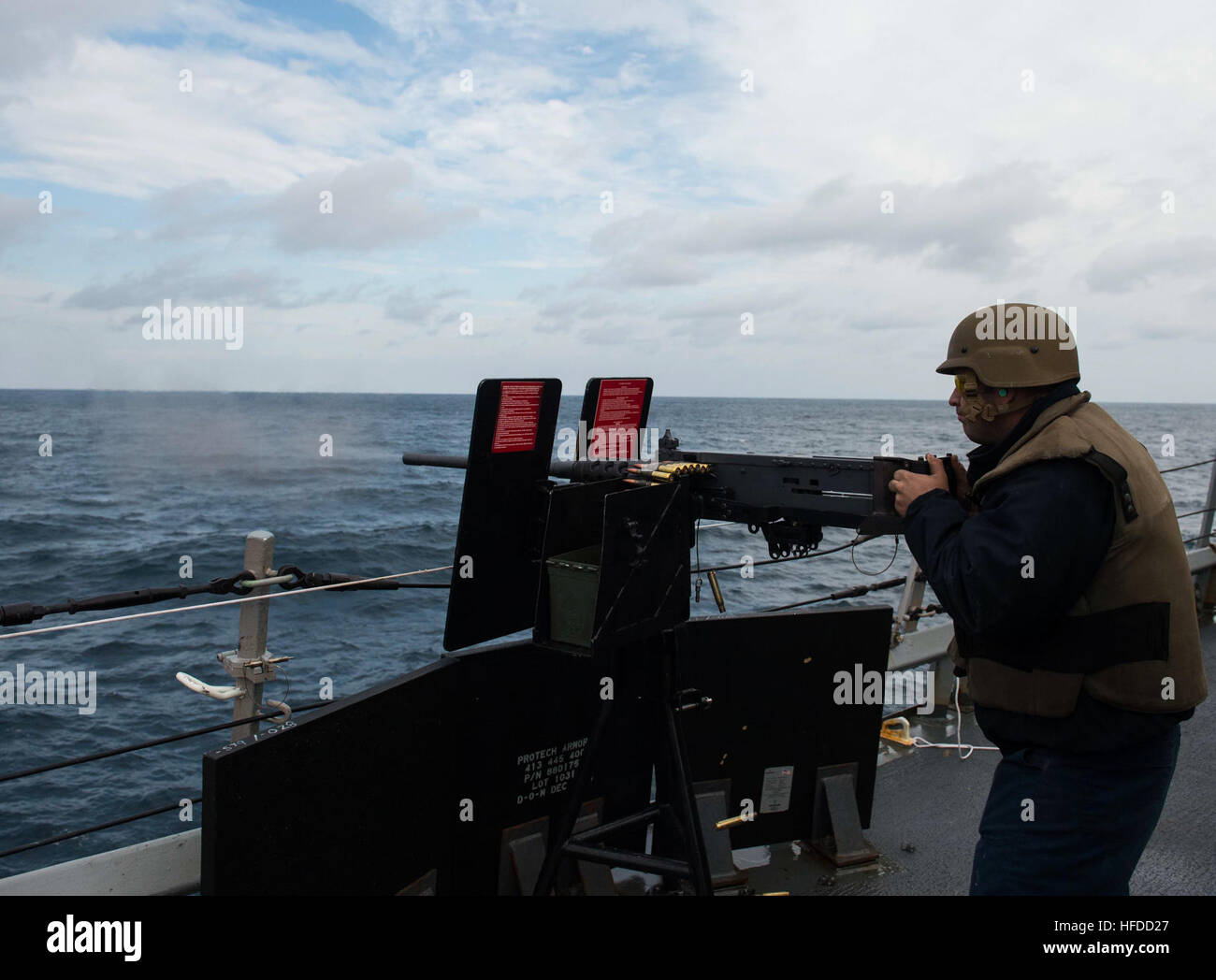 U.S. Navy Gunner's Mate 3rd Class Eric Adkins fires a .50-caliber ...
