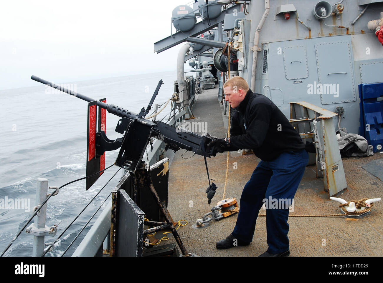 U.S. Navy Gunner's Mate Michael Baglio inspects a .50-caliber machine ...