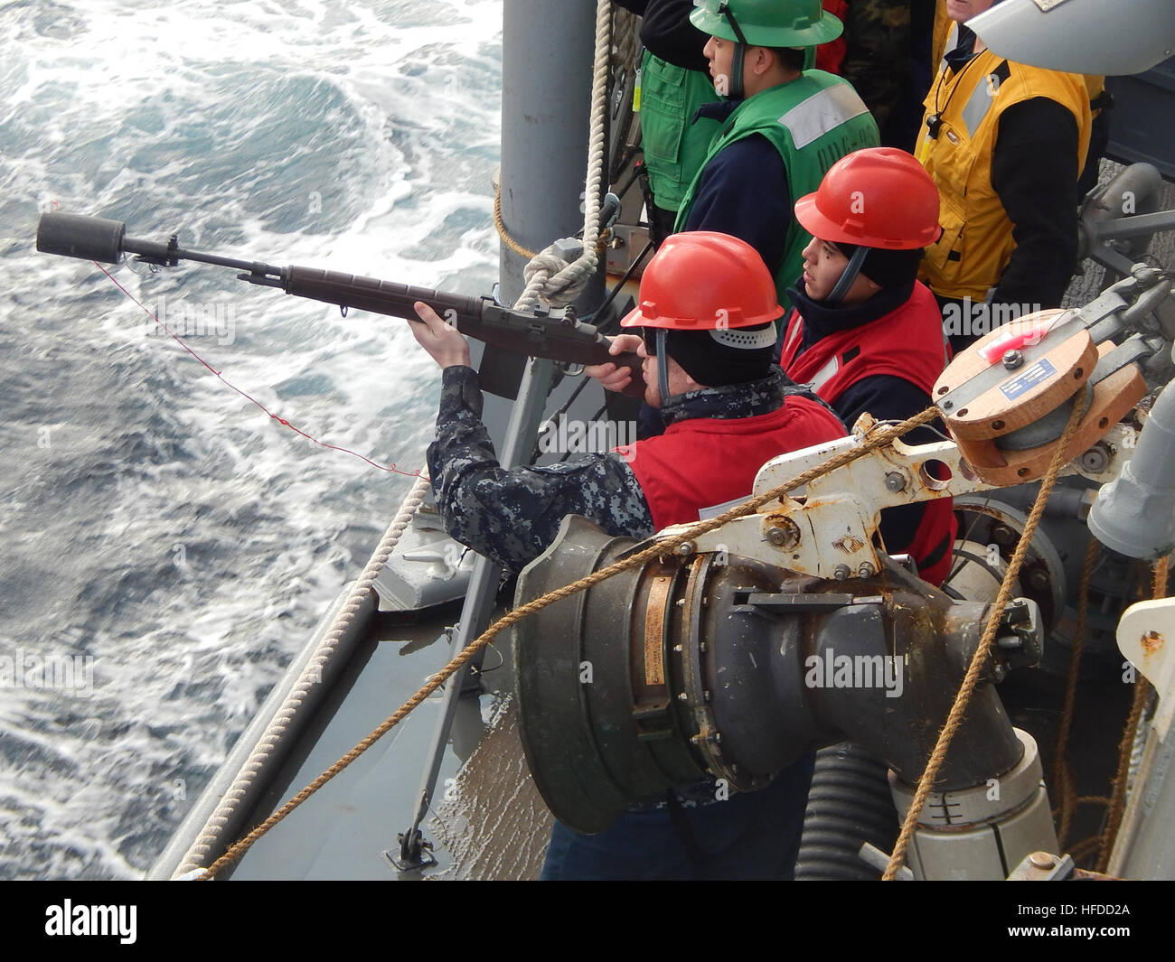 U.S. Navy Gunner's Mate Seaman Dustin Styzej, front, prepares to shoot ...