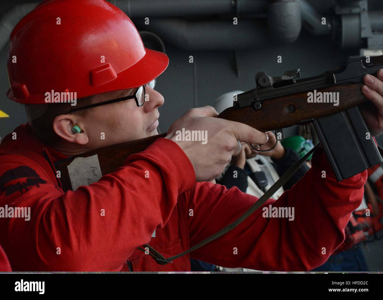 U.S. Navy Gunner's Mate Seaman Thomas Perkins uses an M14 rifle to fire ...