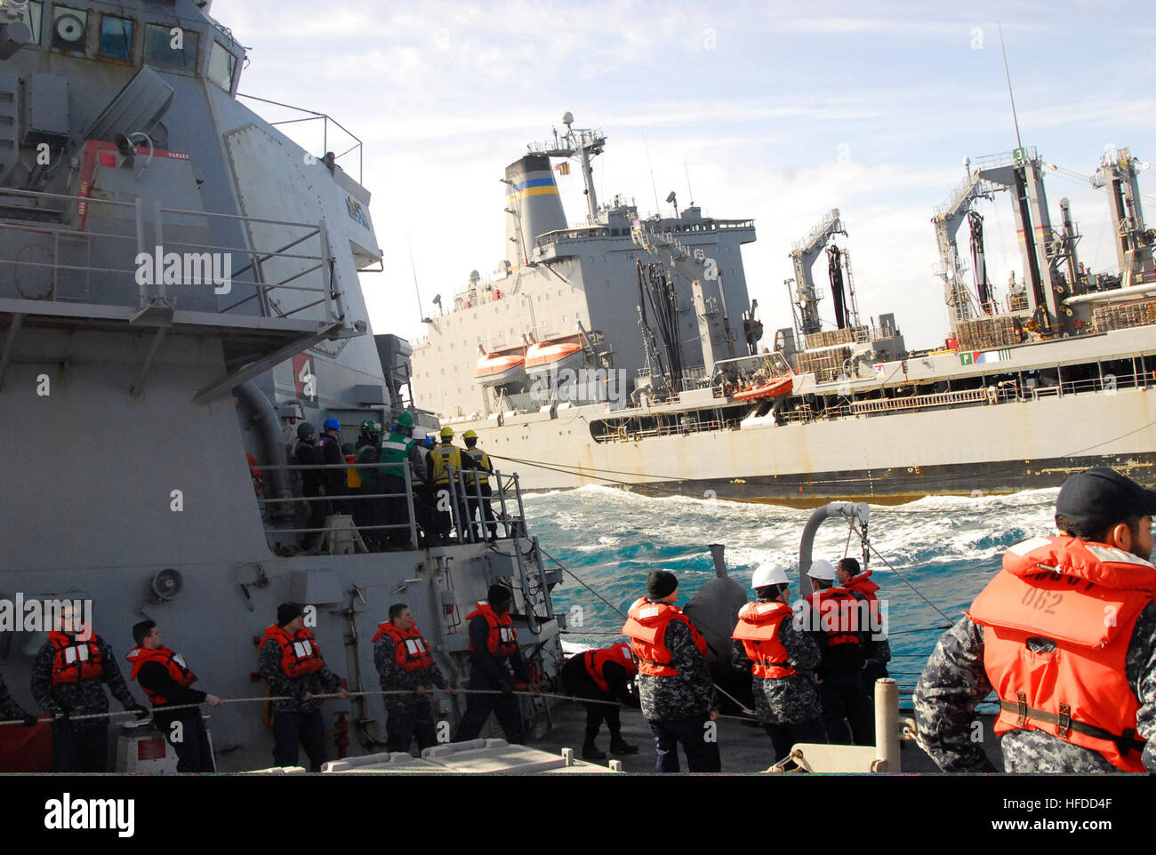 U.S. Navy line handlers aboard the guided missile destroyer USS Cole ...