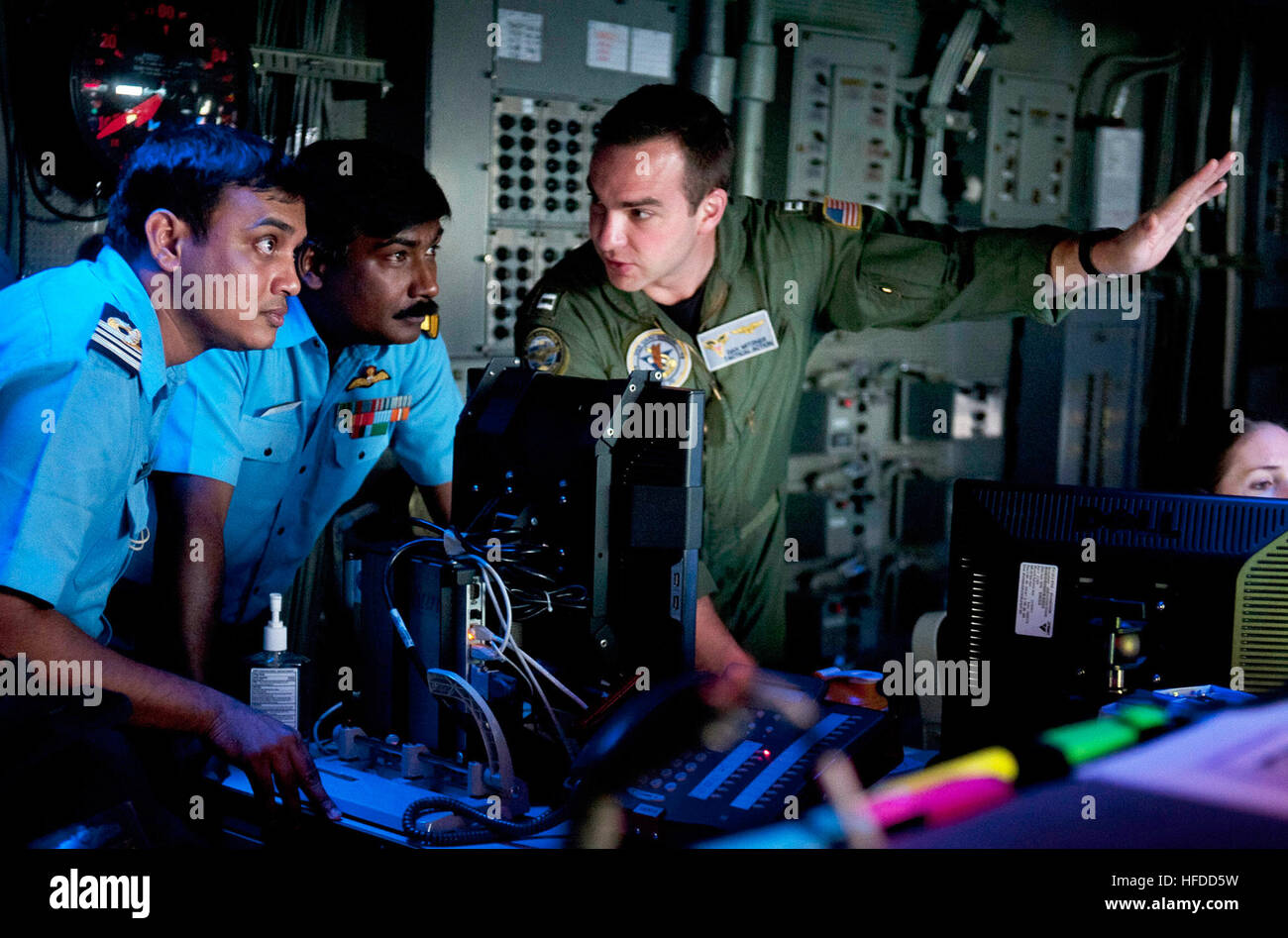 U.S. Navy Tactical Action Officer Lt. Dan Mitzner, right, discusses ...