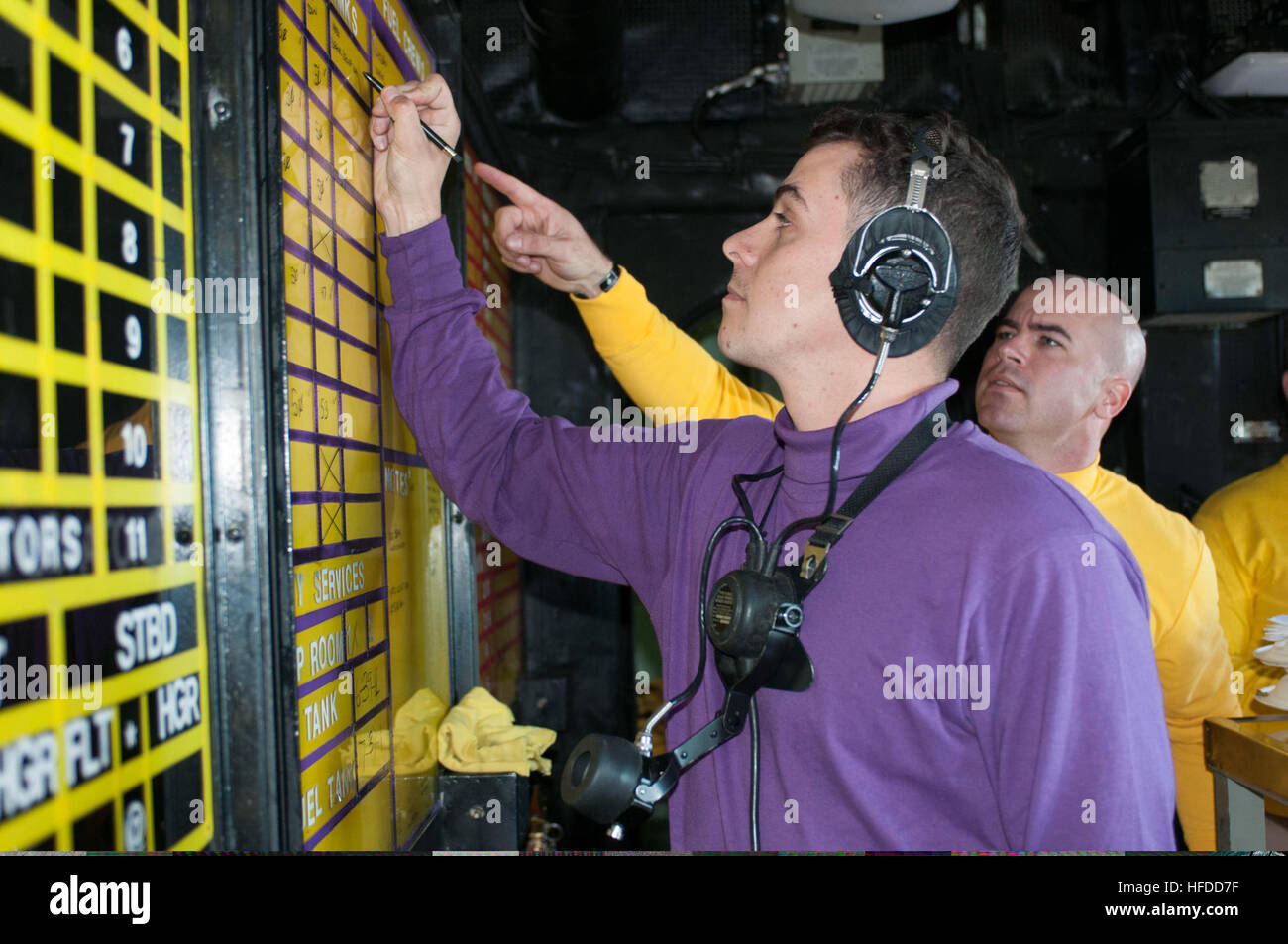Lt. Neil Toohey, flight deck officer, reviews the fuels status board as ...