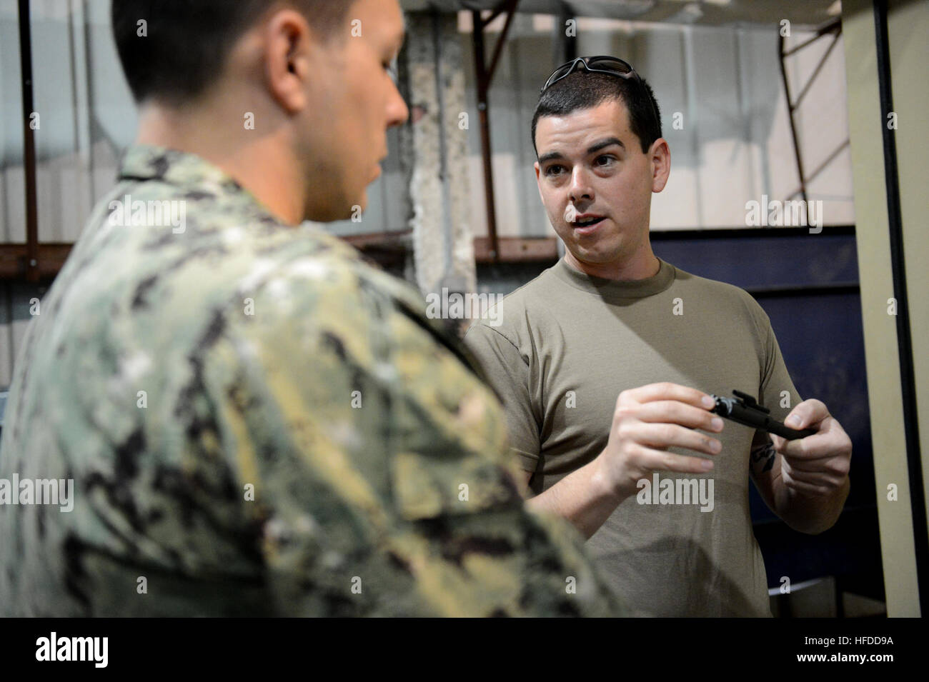 U.S. Navy Mineman 1st Class Thomas Harrell, right, assigned to ...