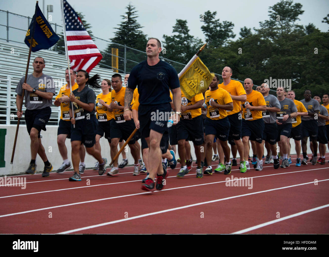 U.S. Navy petty officers first class finish the last stretch of a 5 ...