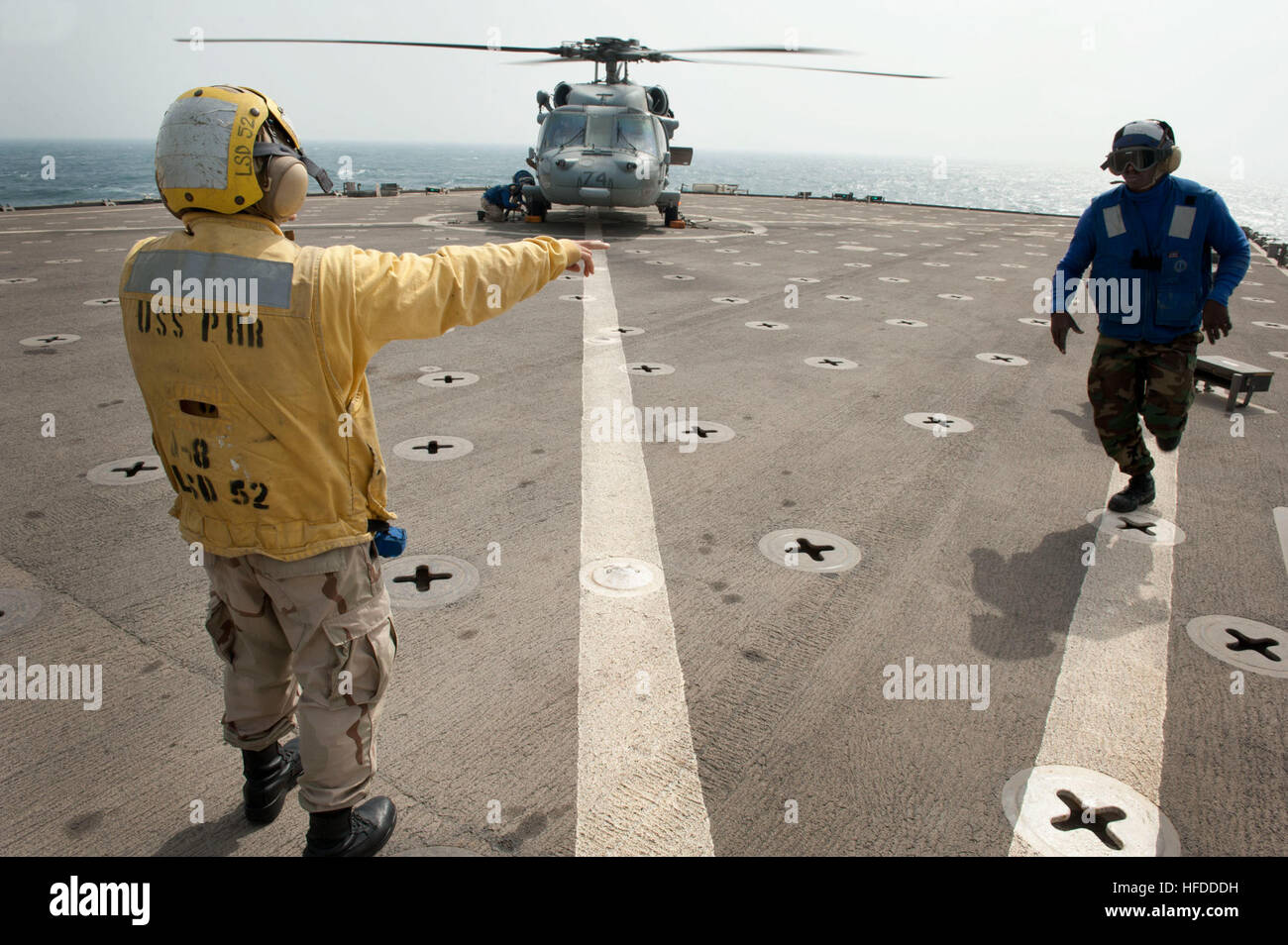 U.S. Navy Seaman Cassandra Collier, left, signals Boatswain's Mate ...