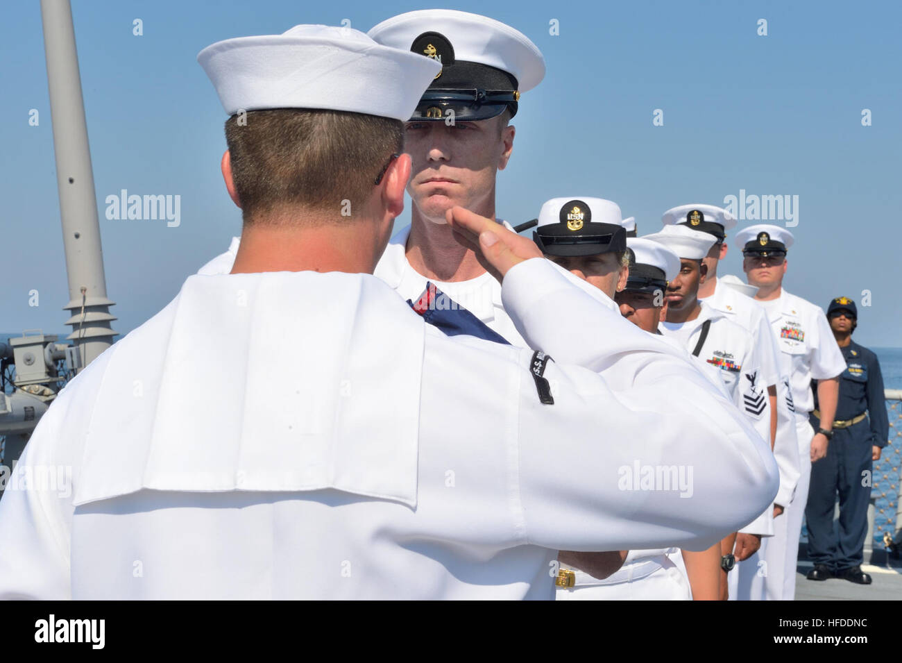 U.S. Sailors assemble on the fantail aboard the guided missile ...