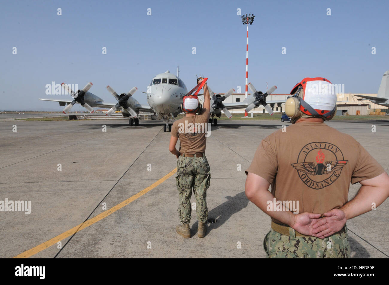 Aviation Ordnanceman Airman Brandon Cardon signals to the pilots of ...