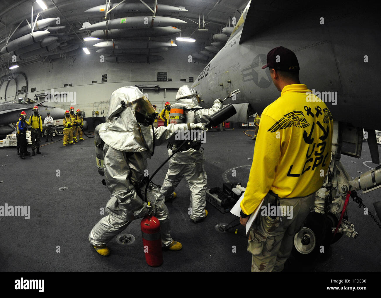 U.S. Sailors wearing hot suits, or firefighting ensemble, ensure a ...