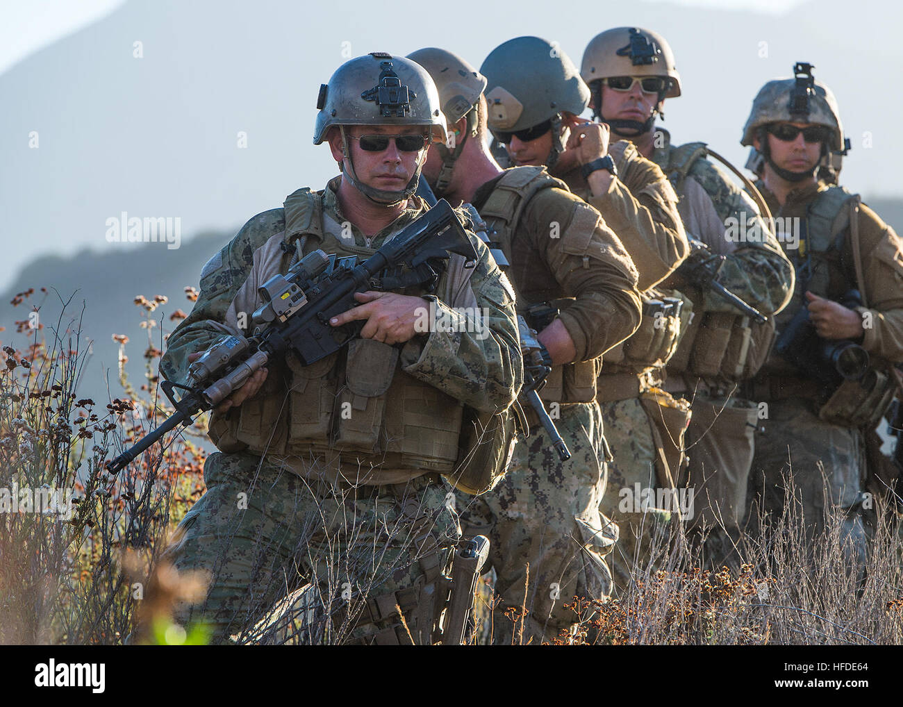 U.S. Service members assigned to various combat camera units patrol ...