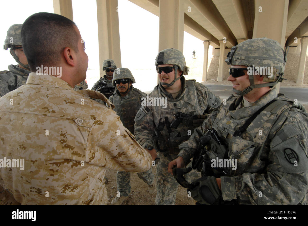 U.S. Soldiers from the 1-150th Armored Reconnaissance Squadron assist ...