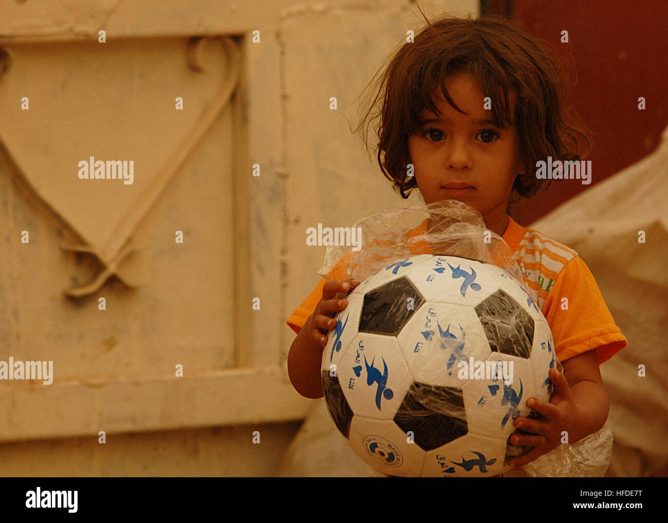 An Iraqi girl is given a soccer ball by U.S. Soldiers from 2nd Platoon ...
