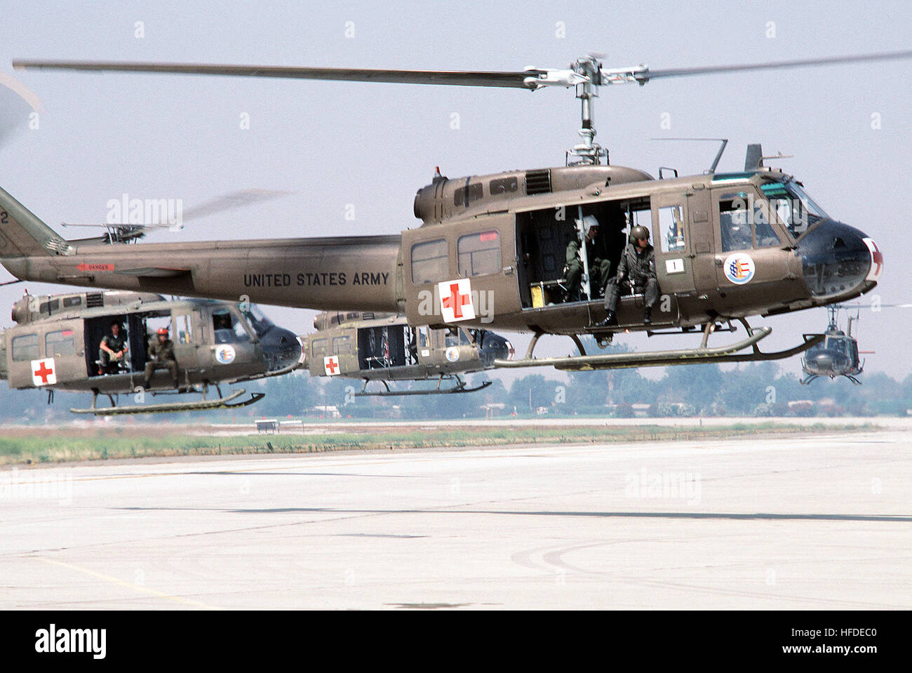 Right side view of an Army UH-1 Iroquois helicopter landing, with two ...