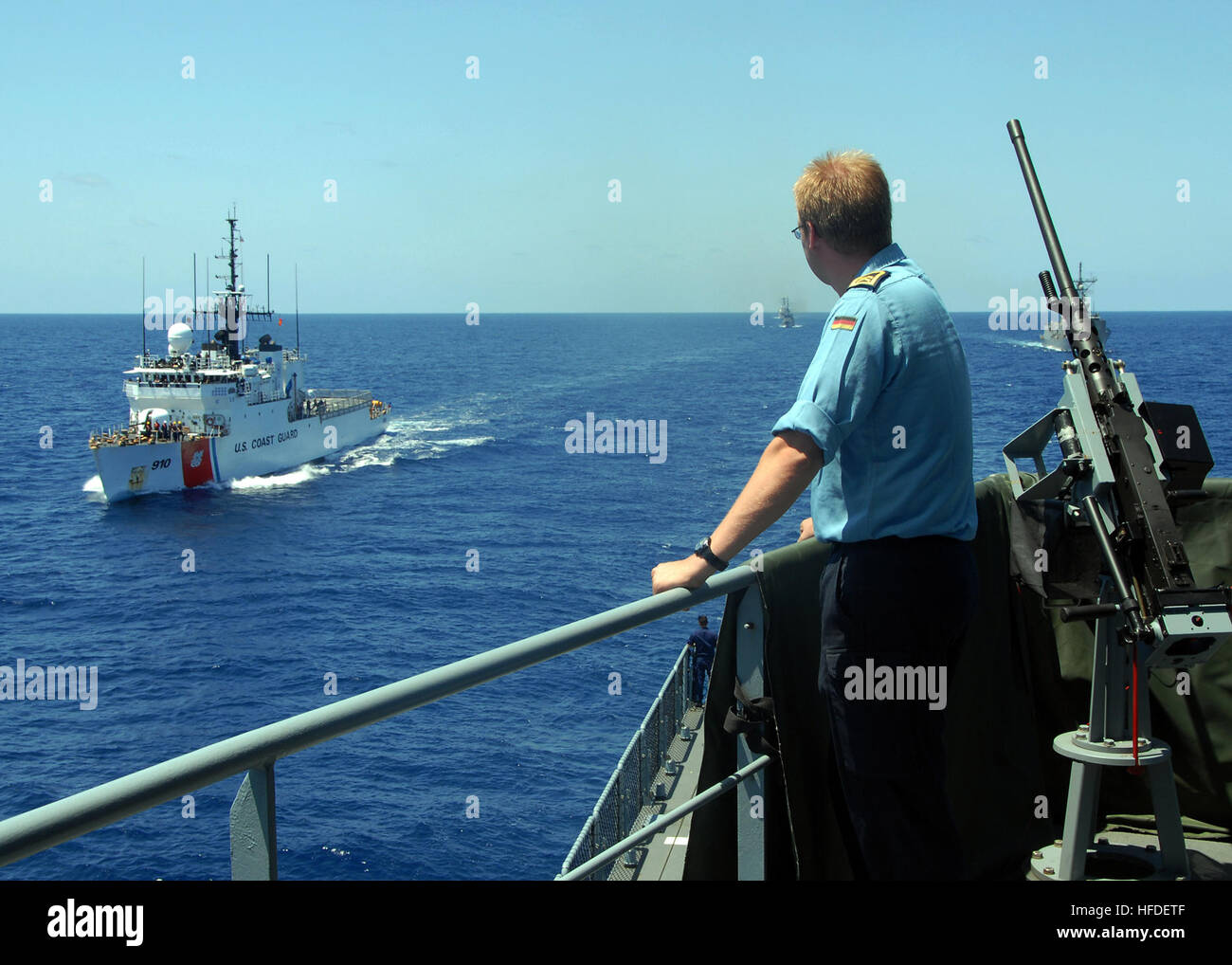 A German sailor watches U.S. Coast Guard cutter Thetis pull alongside ...