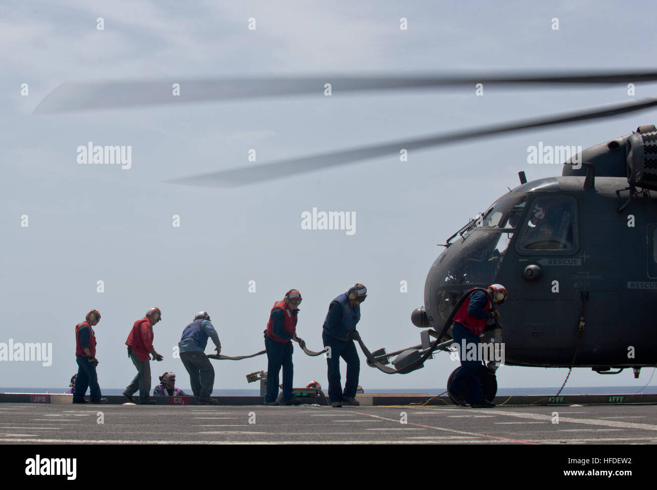 Personnel assigned to Commander, Task Group 52.3, refuel an MH-53E Sea ...