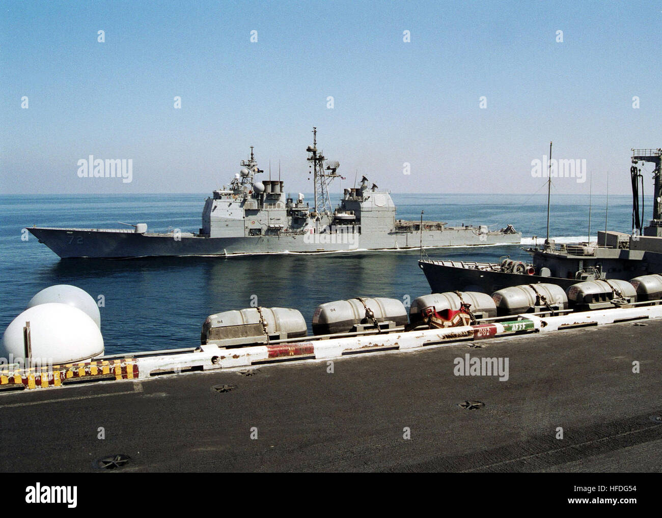 USS Vella Gulf passes USS Theodore Roosevelt during ammunition off-load ...