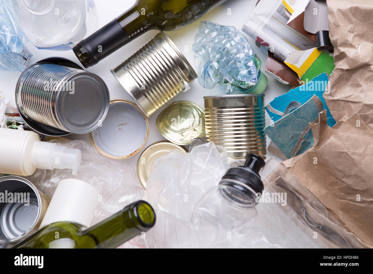 Different recyclable rubbish lies on white table Stock Photo - Alamy