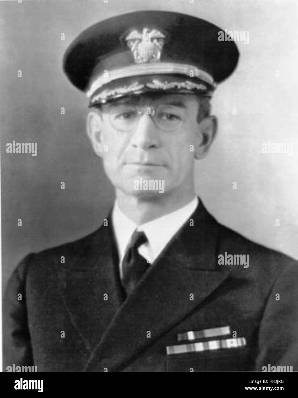 A U.S. Navy service member is depicted in a formal reference entry with ...