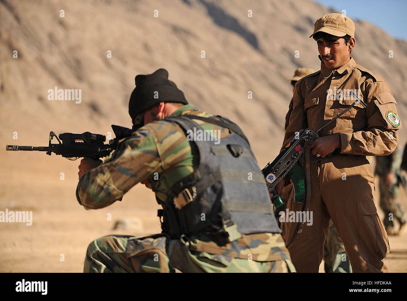 An Afghan National Army commando demonstrates a proper firing position ...