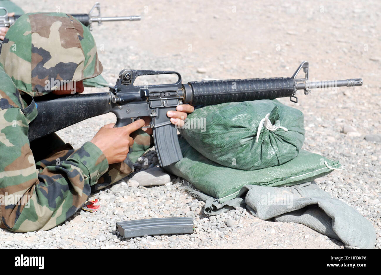 An Afghan National Army recruit fires an M-16 rifle on a small arms ...