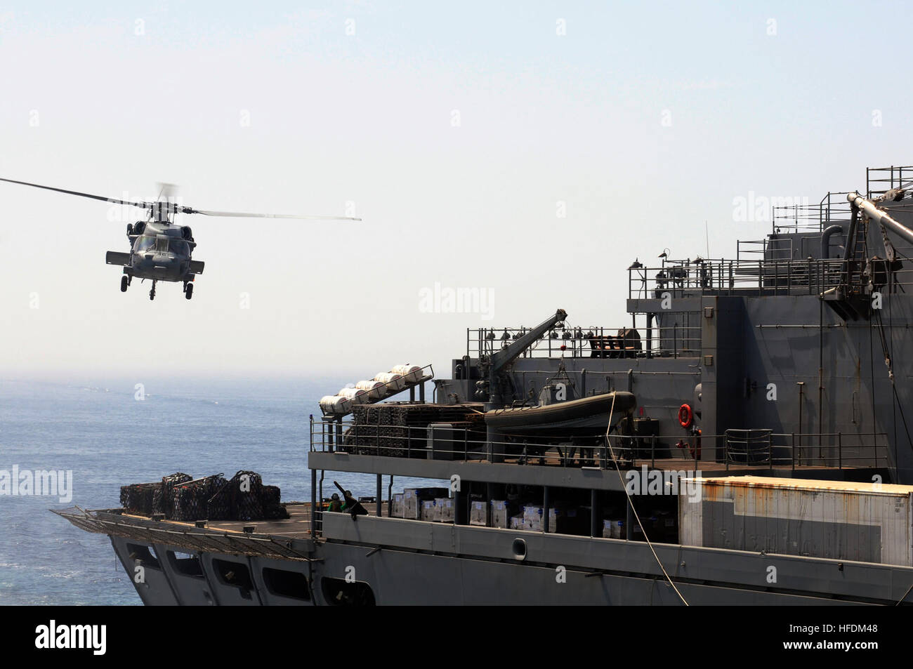 An MH-60S Seahawk helicopter approaches the Military Sealift Command fast combat support ship ...