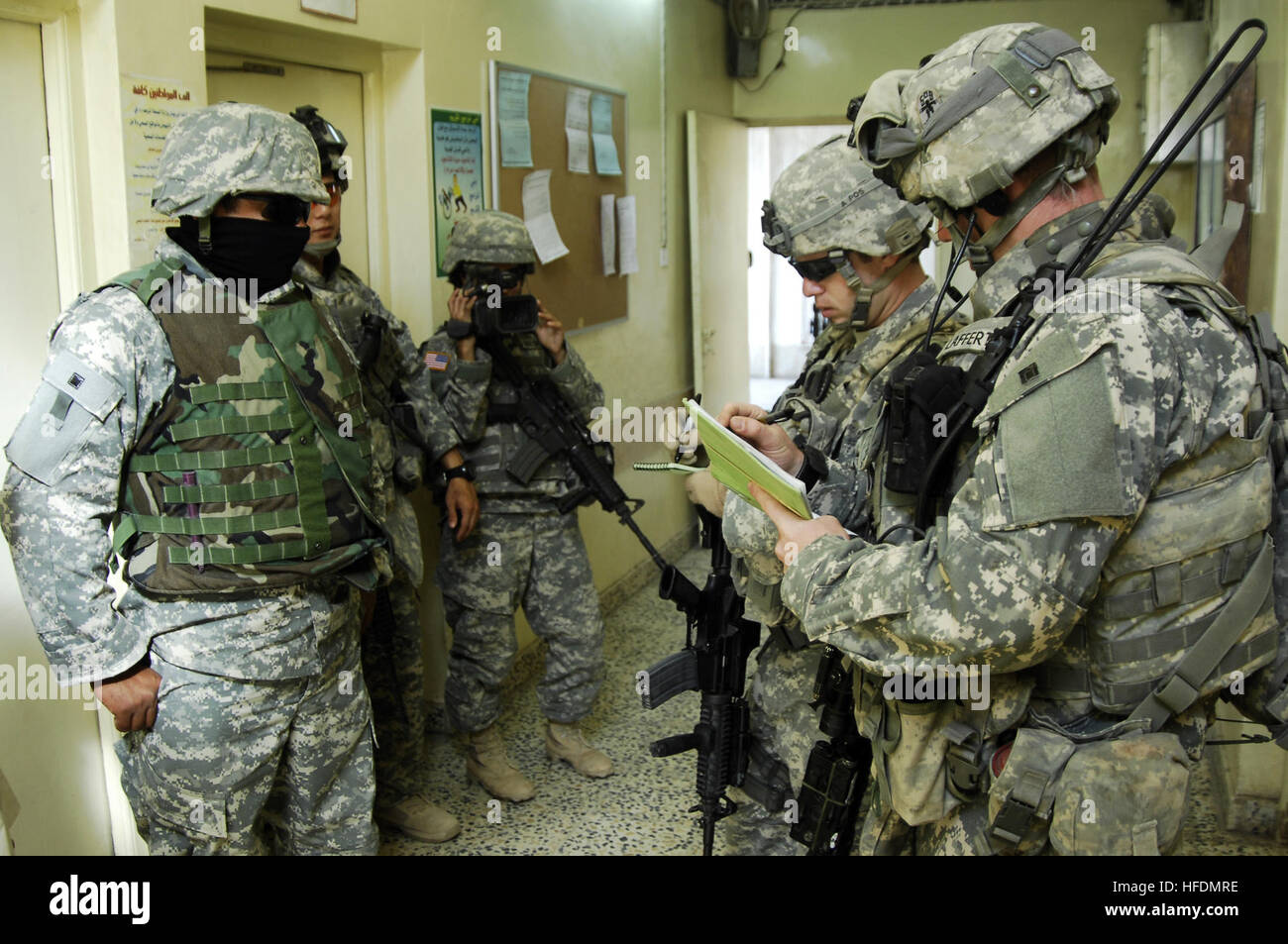 U.S. Army Soldiers take notes during a medical assessment of an Iraqi ...