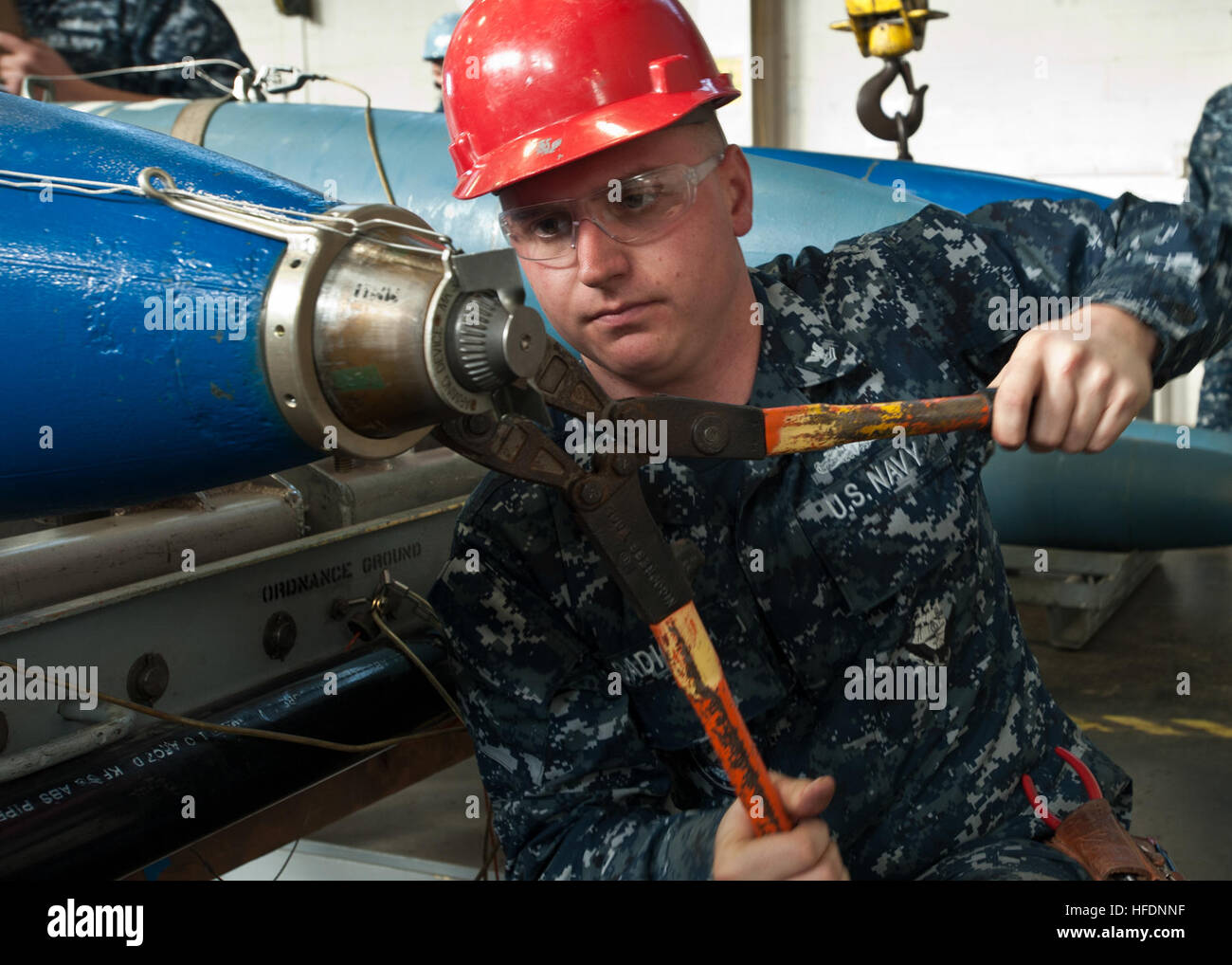 A Sailor routes arming wires to an inert practice mine at Naval Weapons ...
