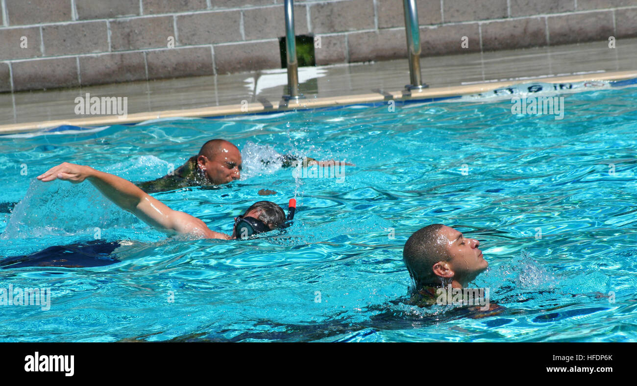 A U.S. Sailor, center, acts as a safety swimmer for Ecuadorian service ...