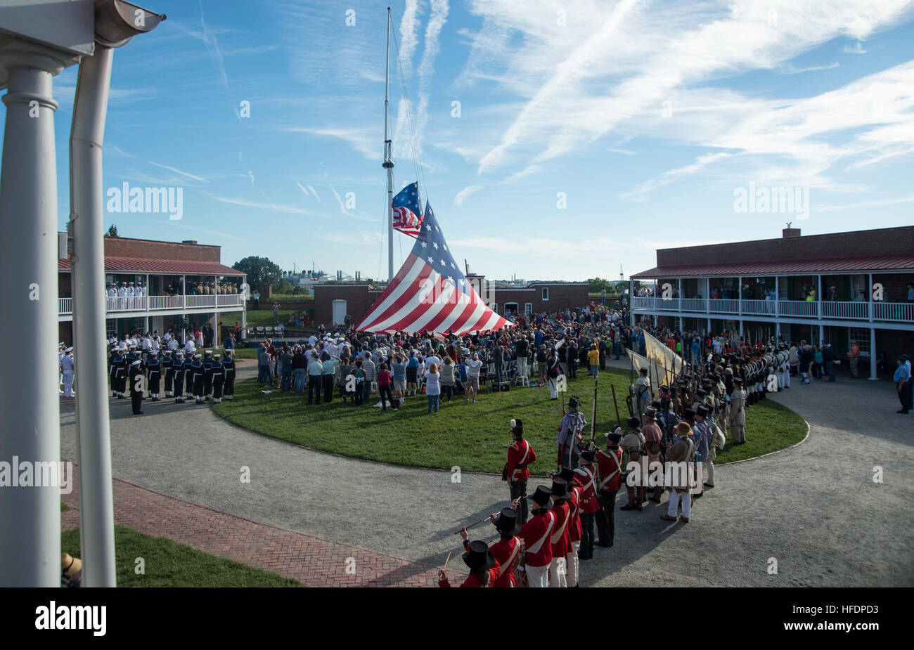 A 30-foot by 42-foot Star-Spangled Banner Flag replica is raised during ...