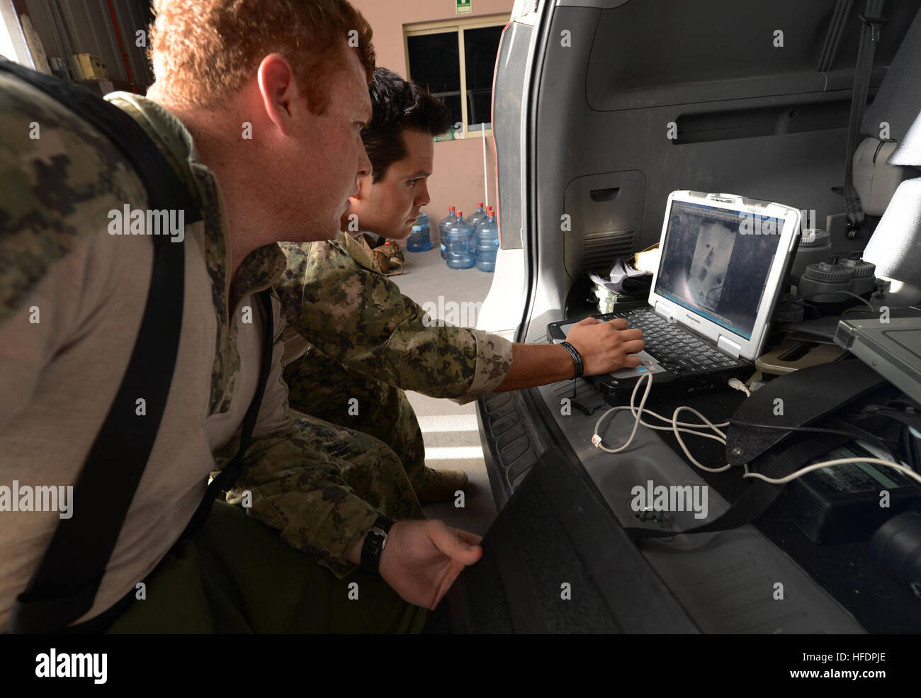 EOD technicians review an x-ray of an unidentified bag during a base ...