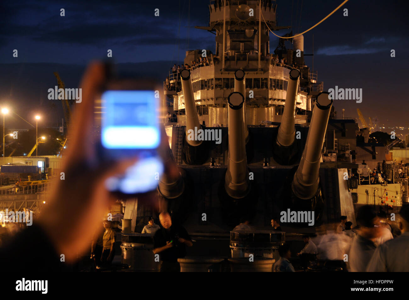 A person takes a photo of the main guns of the Battleship Missouri ...
