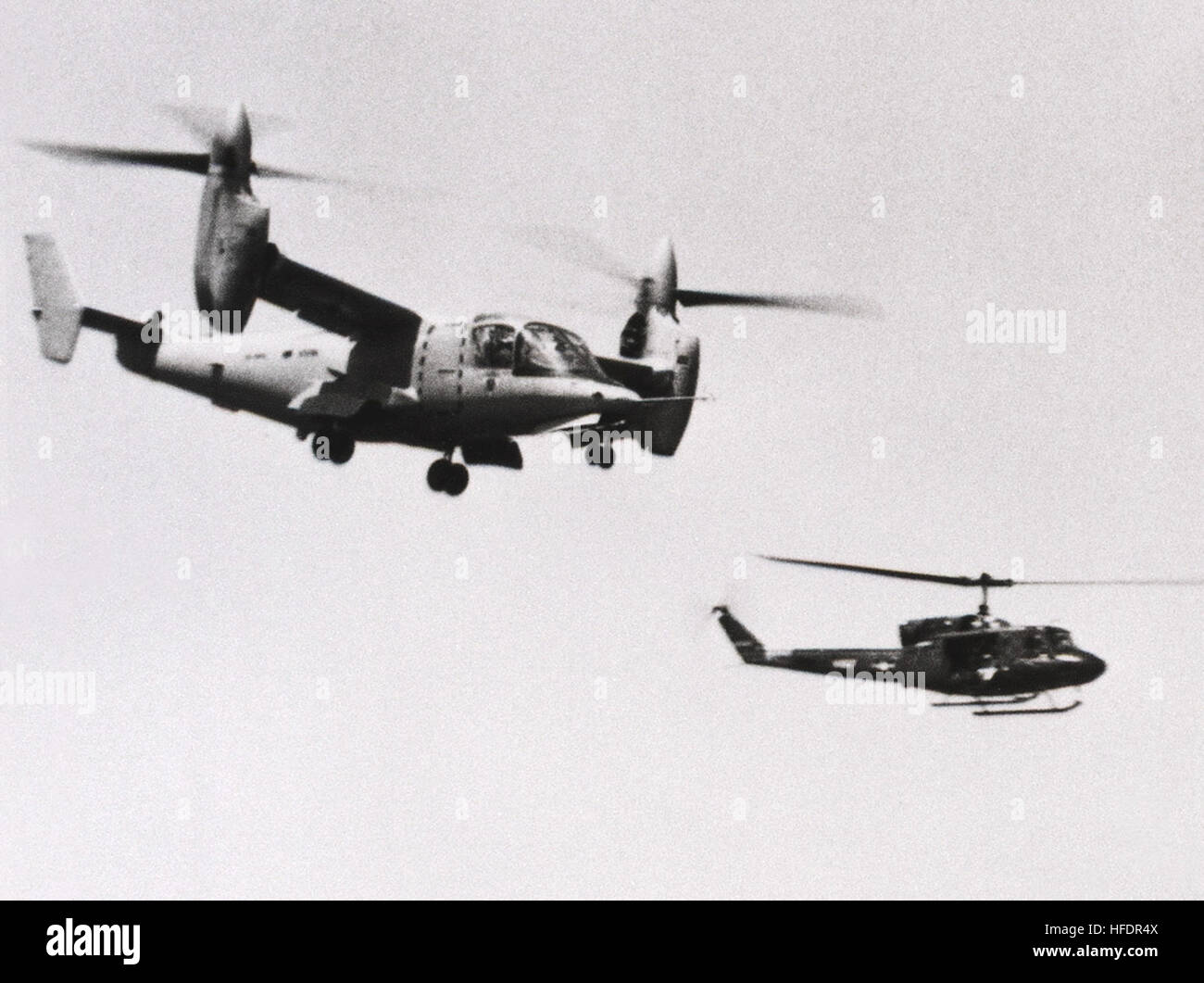 In the photograph, the XV-15, airborne in the helicopter mode, hovers ...